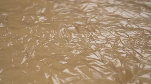 Wrinkled Crumpled textured plastic beige... | Stock Video | Pond5
