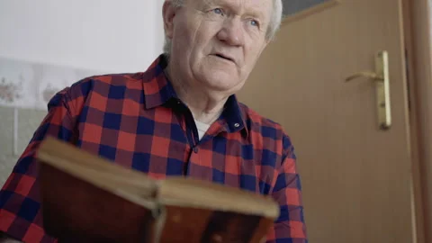 Wrinkled old man reading book with think... | Stock Video | Pond5
