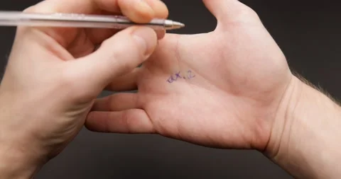 Writing cheat sheet on palms before exam | Stock Video | Pond5