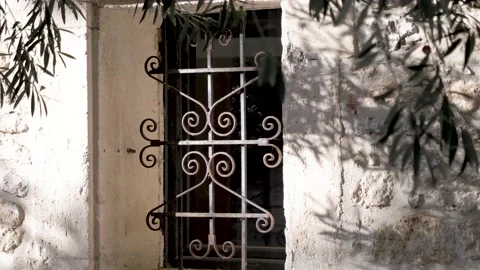 Wrought iron window security bars at a c... | Stock Video | Pond5
