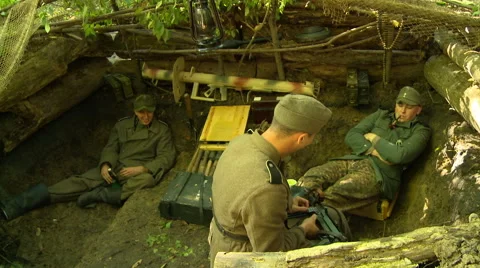 WWII German soldiers relaxing in foxhole | Stock Video | Pond5