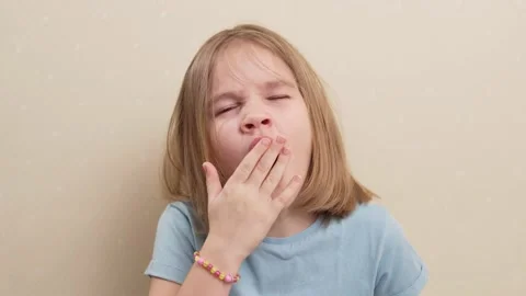 yawning cute little girl with blonde hai... | Stock Video | Pond5