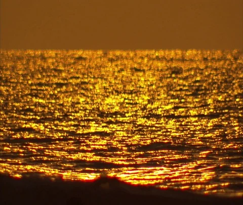 Yellow and orange, golden sunlight on oc... | Stock Video | Pond5