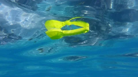 Yellow baby paddle floats on the surface... | Stock Video | Pond5
