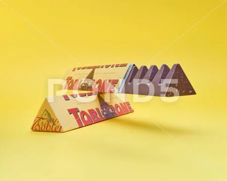 Yellow background with a Toblerone chocolate bar visible, its iconic ...