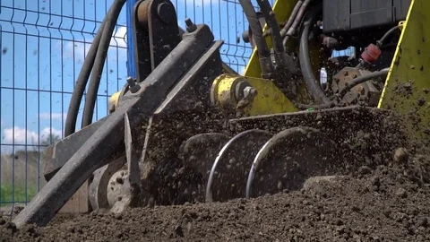 The yellow bulldozer loosens the ground,... | Stock Video | Pond5
