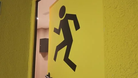 Yellow emergency exit door with pictogr... | Stock Video | Pond5