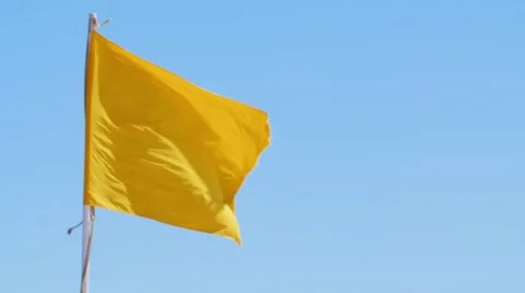 Yellow flag on a background of blue sky | Stock Video | Pond5