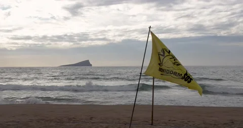 Yellow flag Benidorm SOS waving at the b... | Stock Video | Pond5