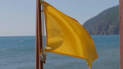 Yellow flag waving from the wind - lifeg... | Stock Video | Pond5