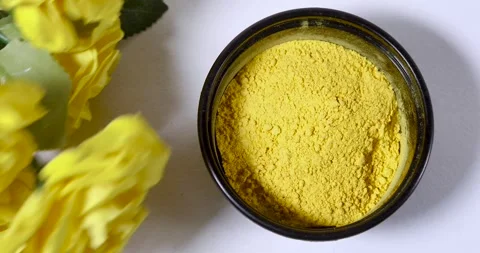 Yellow Holi powder and flower on white s... | Stock Video | Pond5