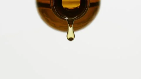 Yellow liquid is dripping from brown bot... | Stock Video | Pond5