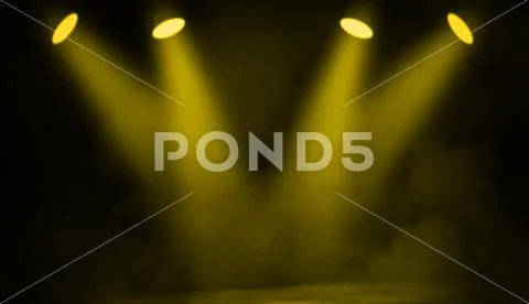 Yellow projector background. Spotlight stage with smoke on the floor ...