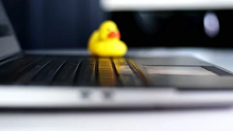 Yellow Rubber Duck Sitting on Laptop As ... | Stock Video | Pond5