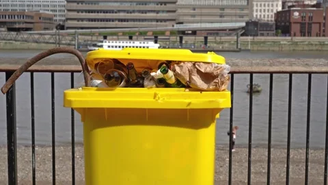 Yellow rubbish bin overflowing with wast... | Stock Video | Pond5