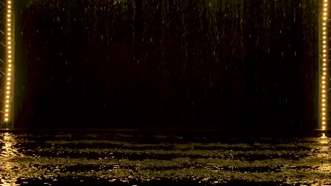 Yellow spatters rain fall against the ba... | Stock Video | Pond5