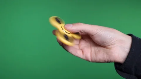 Yellow Spinner Spinning on a Green Scree... | Stock Video | Pond5