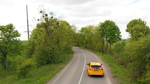 A yellow sports car moves along a beauti... | Stock Video | Pond5
