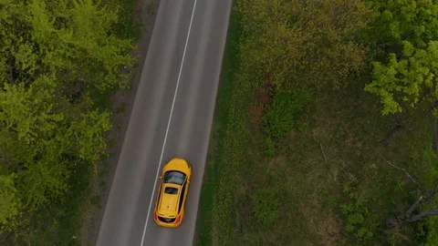 A yellow sports car moves along a beauti... | Stock Video | Pond5