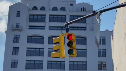 A yellow traffic light hangs at intersec... | Stock Video | Pond5