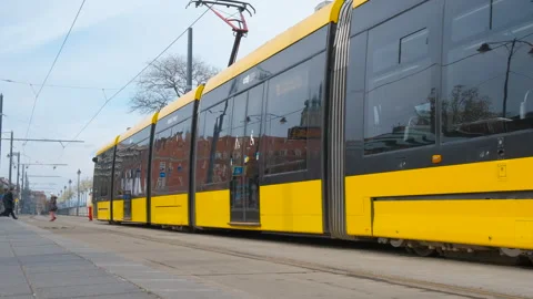 Yellow tramway arrives on the stop. | Stock Video | Pond5