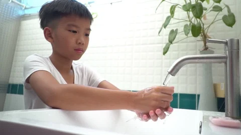 Younb boy wash his hand | Stock Video | Pond5