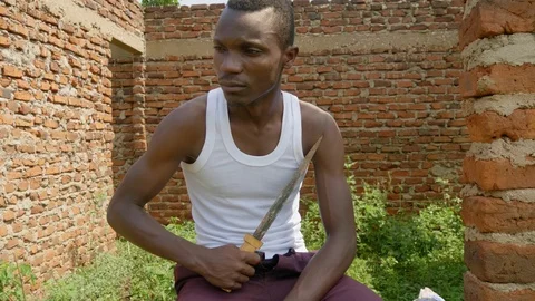 A young African gangster is holding a kn... | Stock Video | Pond5