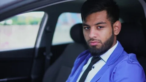 Young arab man in formal suit sitting in... | Stock Video | Pond5