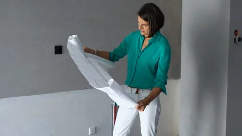 Young architect woman reading blueprints... | Stock Video | Pond5