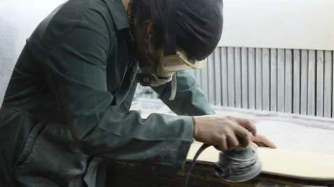 Young artisan man sandering the deck wit... | Stock Video | Pond5