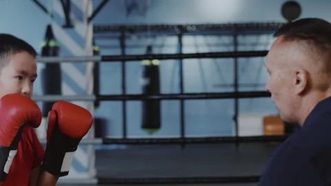 Young asian boy in boxing gloves perform... | Stock Video | Pond5