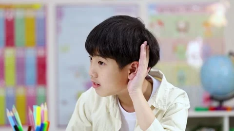 Young Asian Boy Cupping Ear to Listen Ca... | Stock Video | Pond5