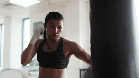 Young asian female boxer with wrapped ha... | Stock Video | Pond5