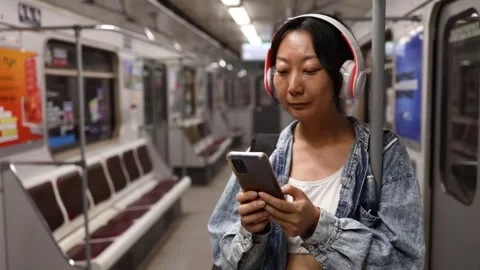young asian girl rides the subway lookin... | Stock Video | Pond5