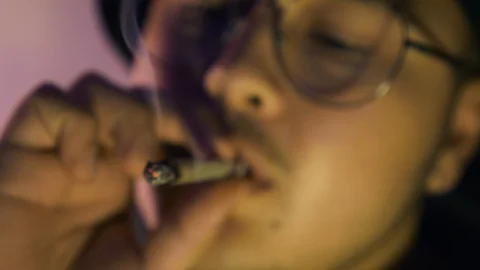 Young Asian Male Taking a Hit of a Marij... | Stock Video | Pond5