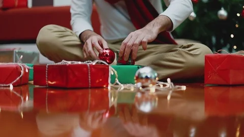 Young Asian man making a gift box in the... | Stock Video | Pond5