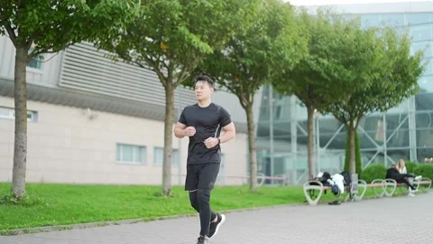young asian man runner down the street o... | Stock Video | Pond5