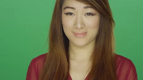 Young Asian woman awkwardly smiling, on ... | Stock Video | Pond5