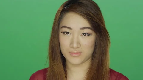 Young Asian woman awkwardly staring, on ... | Stock Video | Pond5