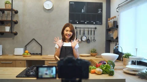 Young asian woman in kitchen recording v... | Stock Video | Pond5