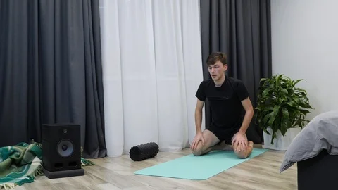 Young athlete stretches hip muscles, ham... | Stock Video | Pond5