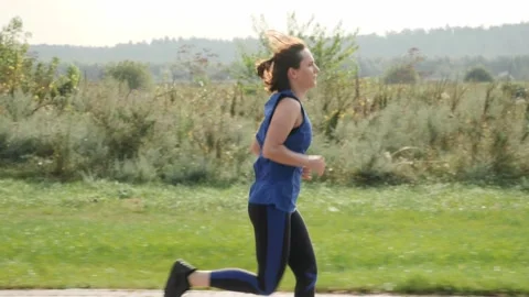 Young athlete woman running fast down th... | Stock Video | Pond5