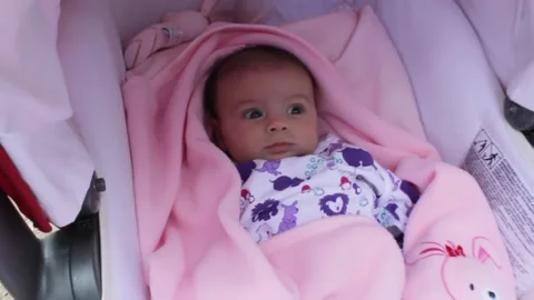 Young baby moving and making funny face ... | Stock Video | Pond5