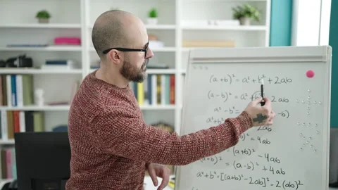 Young bald man teacher teaching maths on... | Stock Video | Pond5