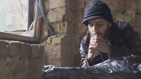 Young bearded homeless smoking cigarette | Stock Video | Pond5