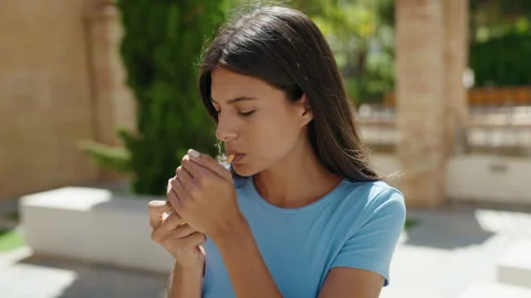 Young beautiful hispanic woman smoking a... | Stock Video | Pond5