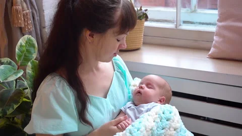 Young beautiful mother cradles her sleep... | Stock Video | Pond5