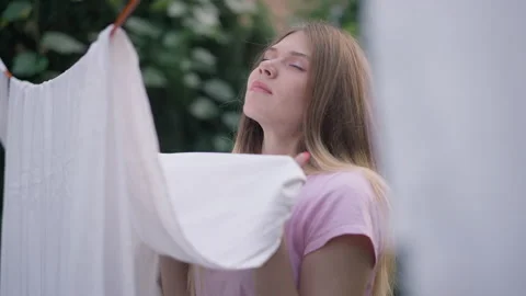 Young beautiful woman smelling clean fre... | Stock Video | Pond5