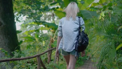 Young beautiful woman walking in shade o... | Stock Video | Pond5