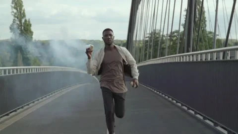 Young Black Man Running with Smoke Bomb ... | Stock Video | Pond5